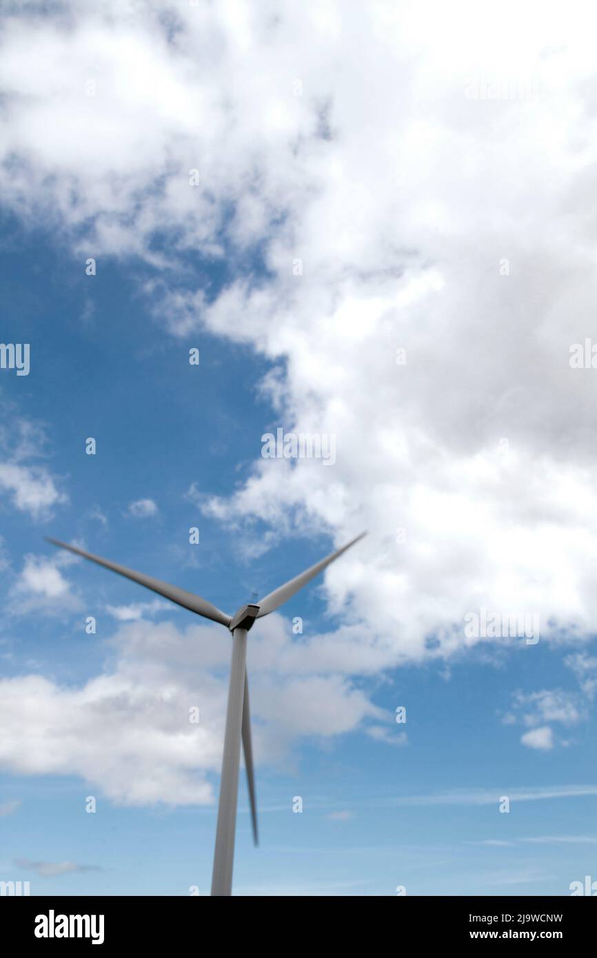 Wind turbine against a blue sky Stock Photo - Alamy