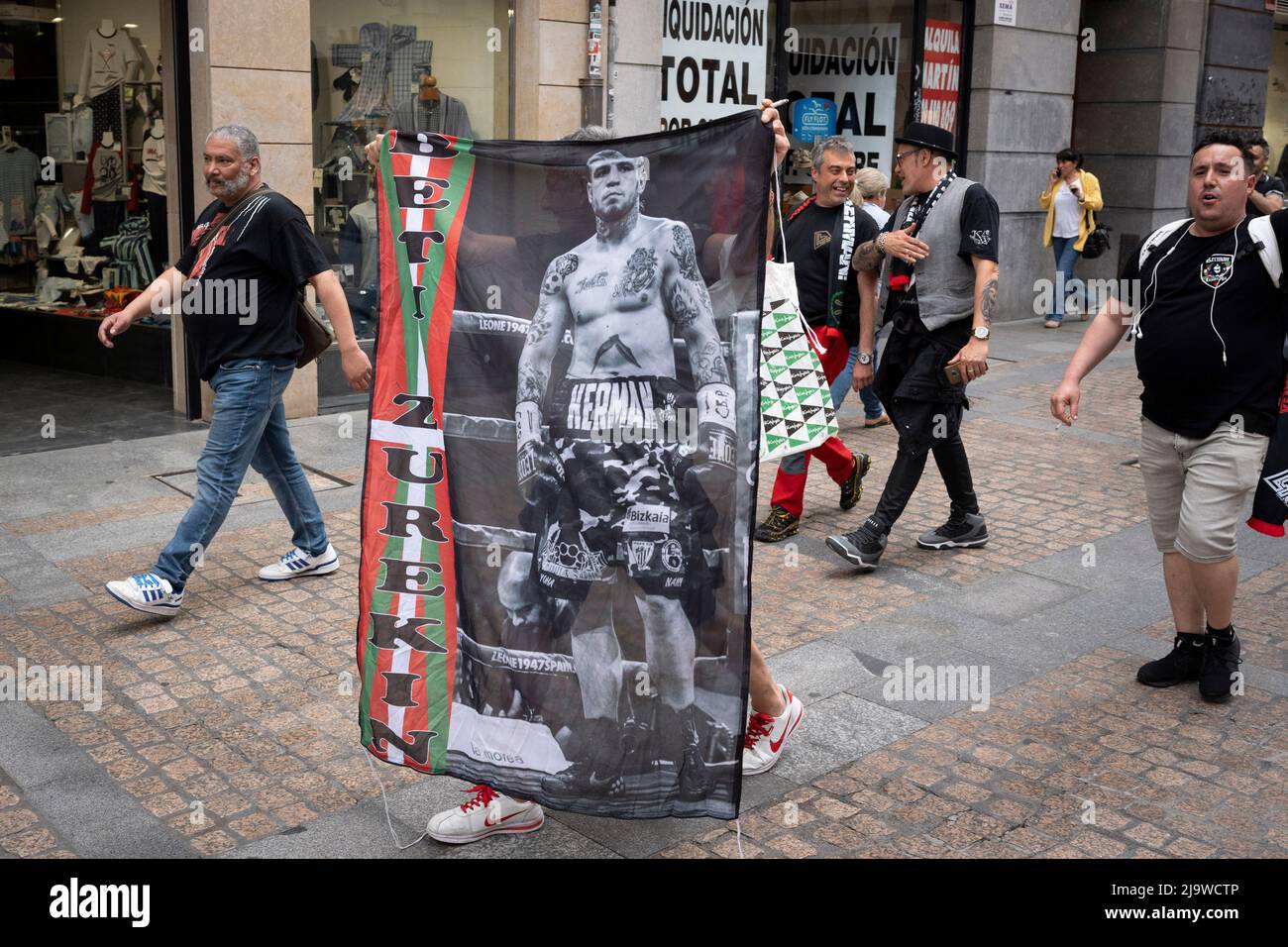 Fans of a Spanish boxer called Herman, walk through Bilbao's old town ...