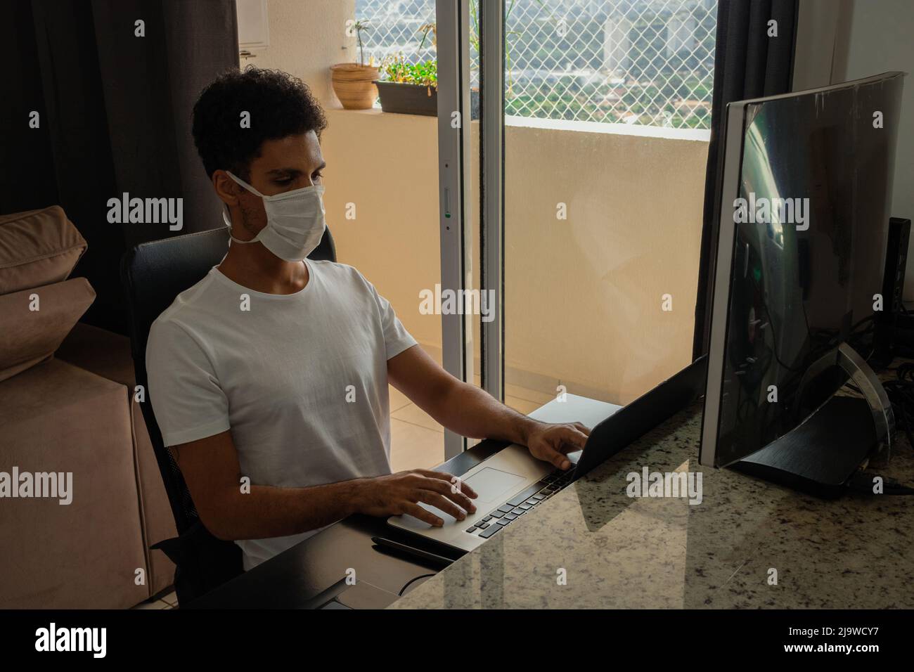 Black man at computer desk Stock Photo - Alamy
