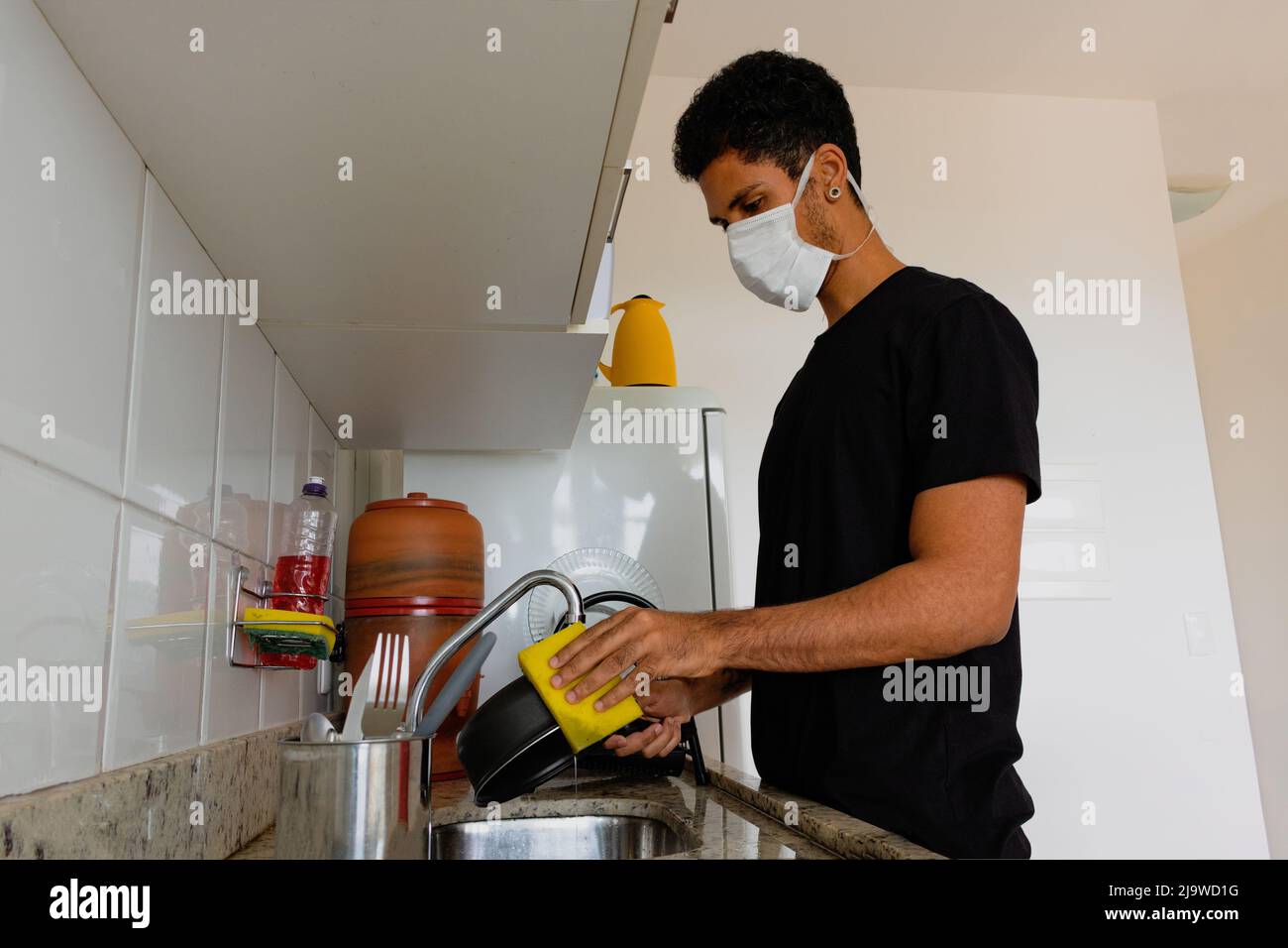 Man adult black washing dishe in kitchen Stock Photo - Alamy