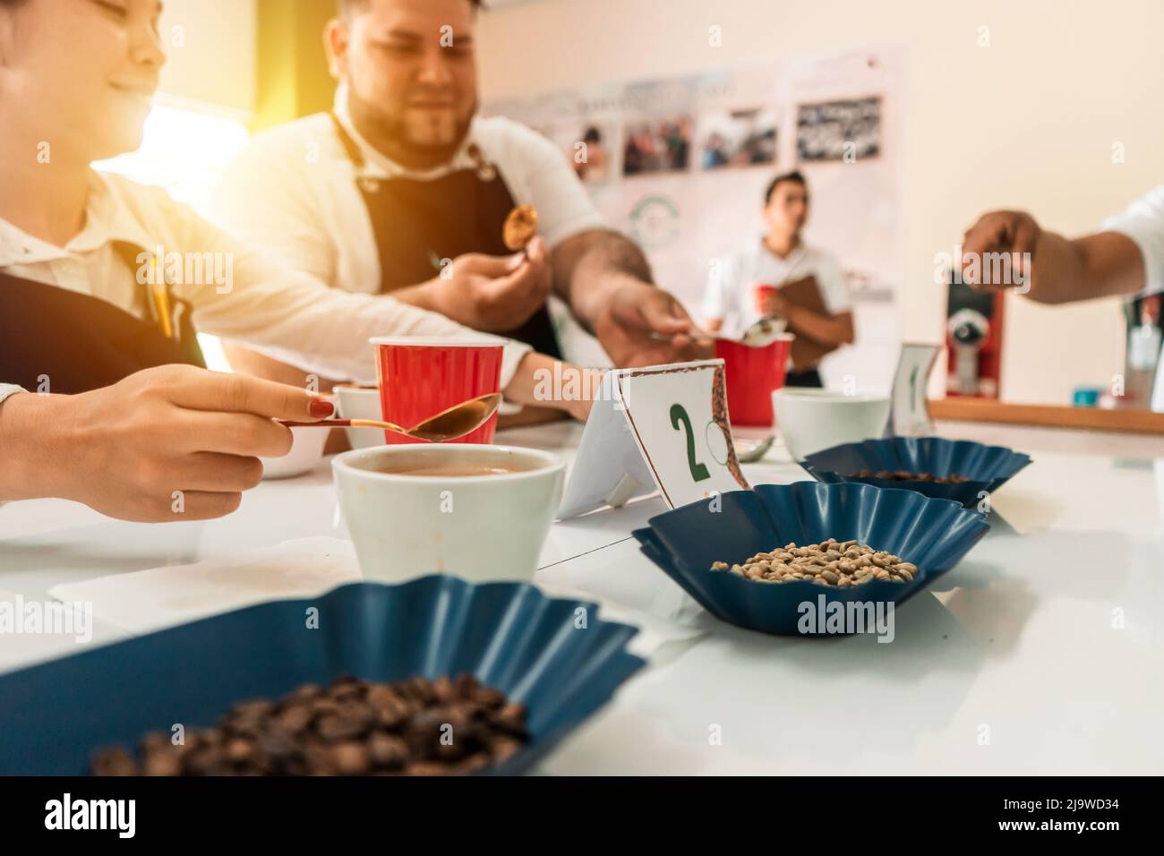Group of professional coffee tasters examining quality during a ...