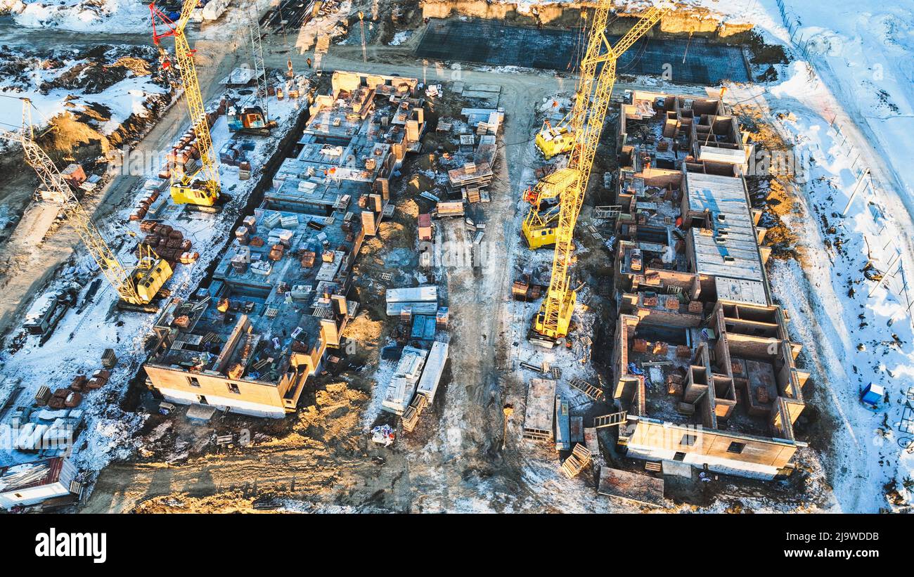 Construction of a residential building. View from above. Snowy winter ...