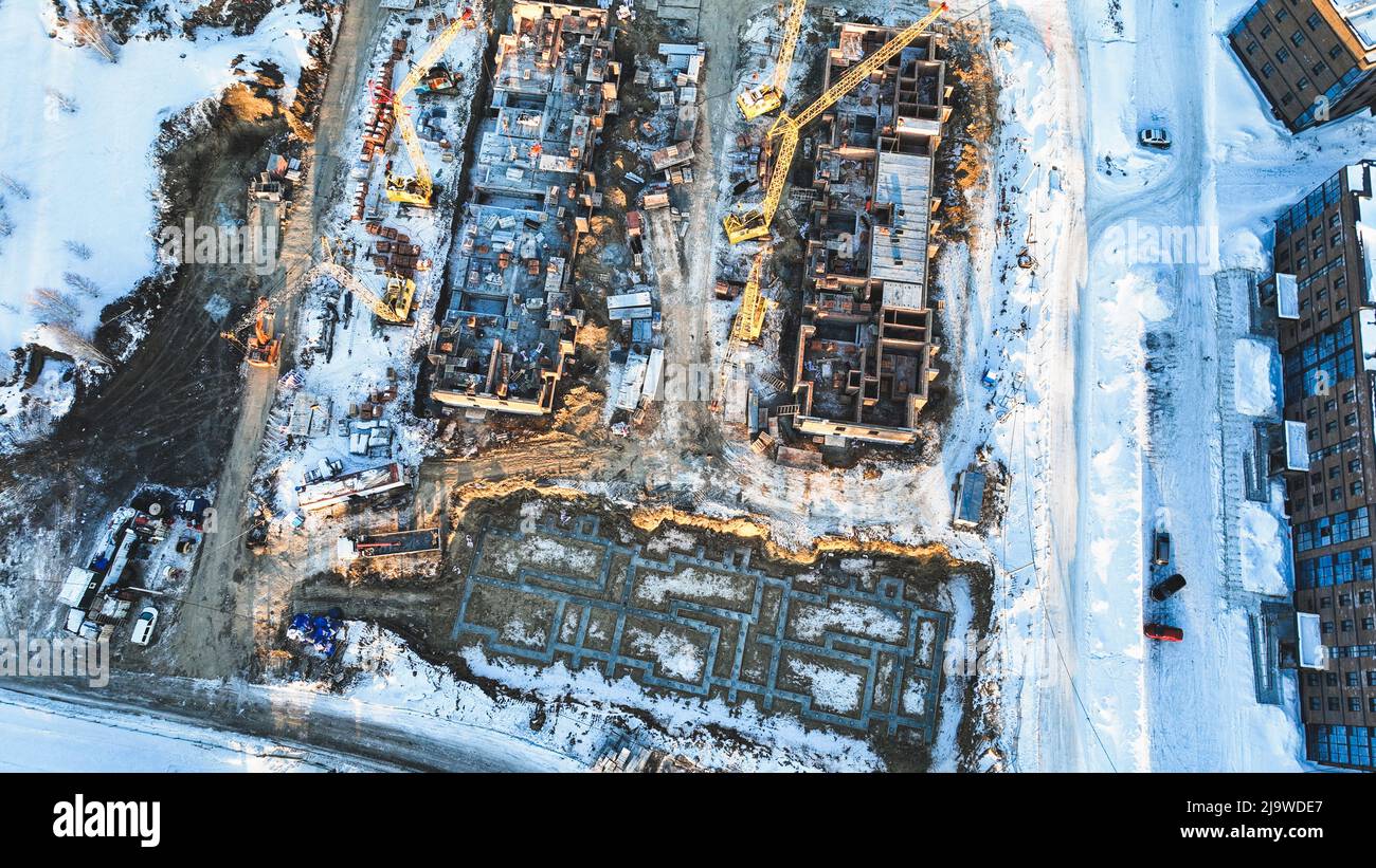 Construction of a residential building. View from above. Snowy winter ...