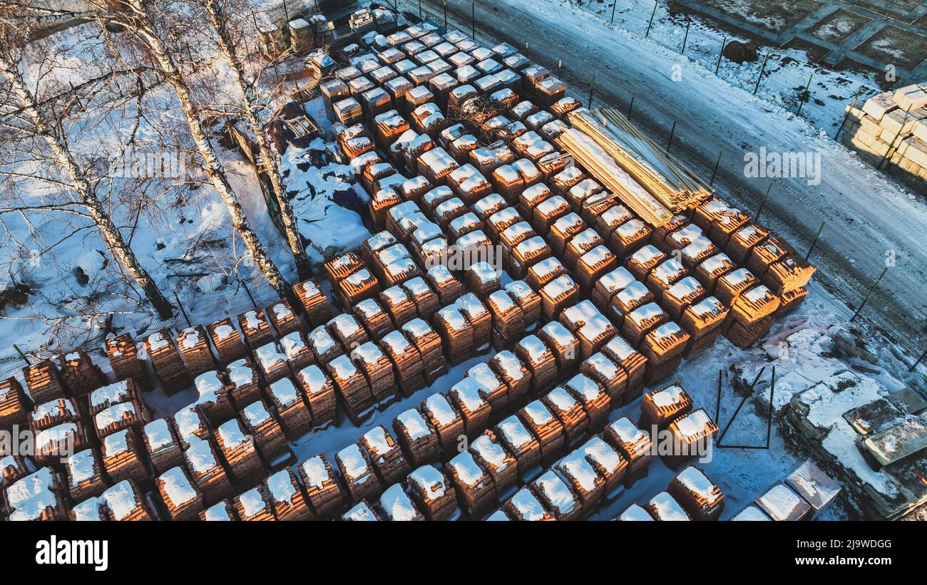 Pallets of bricks for construction. Outdoor storage in winter ...