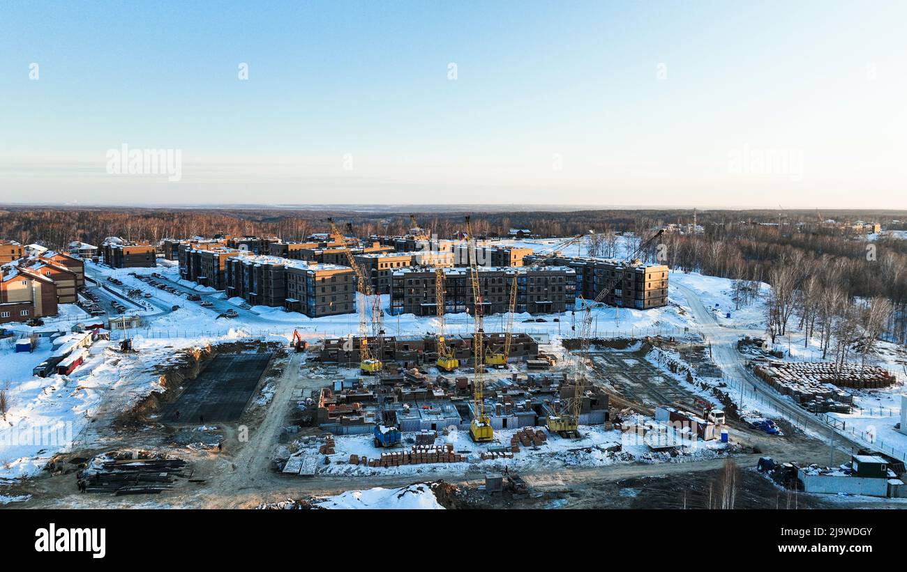 Construction of a residential building. View from above. Snowy winter ...