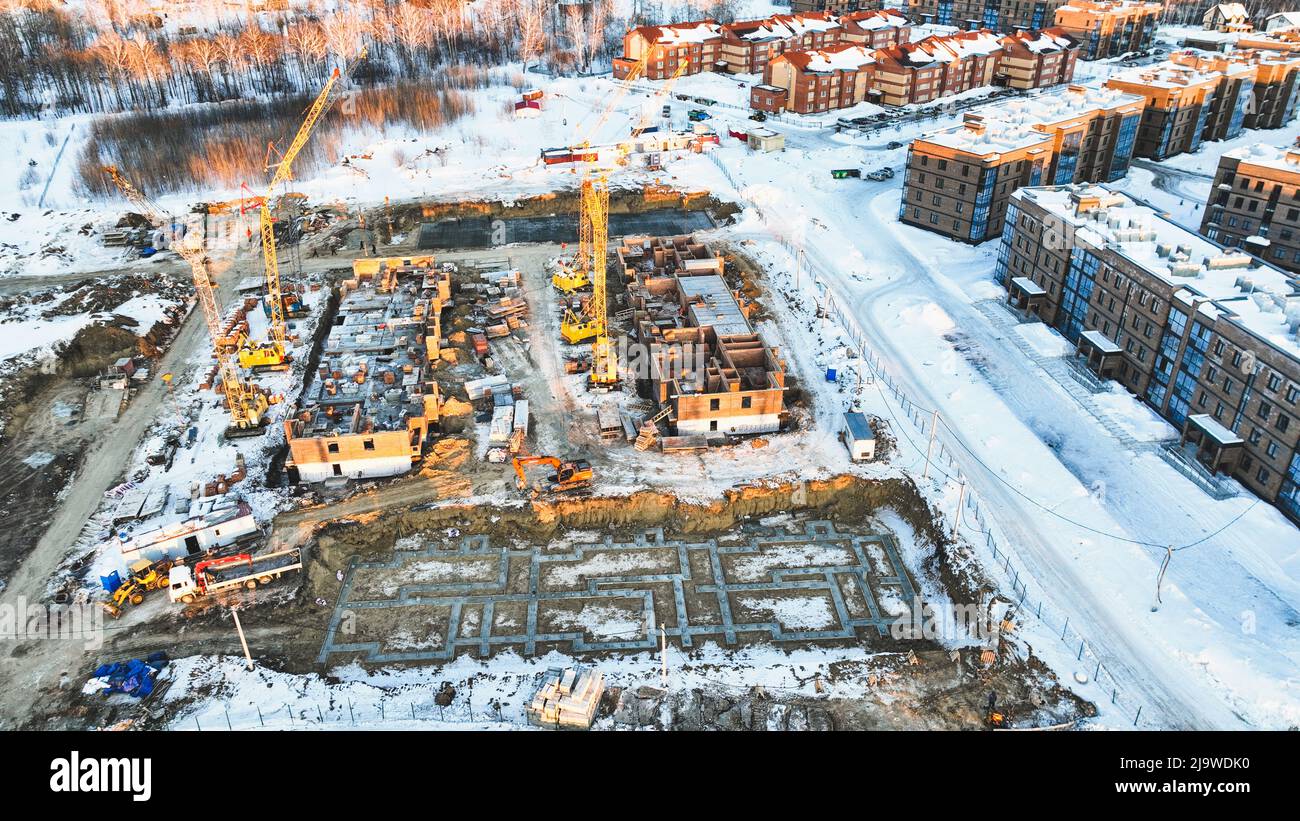 Construction of a residential building. View from above. Snowy winter ...