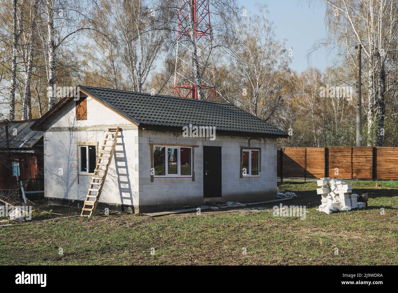 Unfinished block house on a country area. Without facade decoration ...
