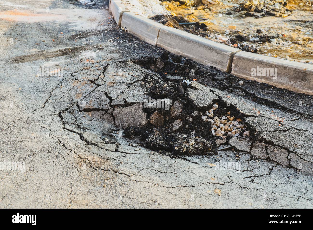Asphalt swelling close-up. Pothole and pit on road Stock Photo - Alamy