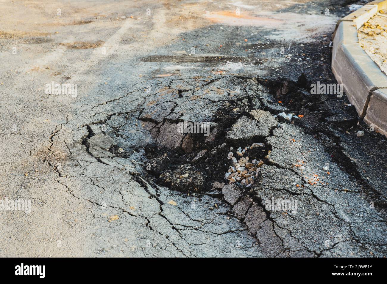 Asphalt swelling close-up. Pothole and pit on road Stock Photo - Alamy