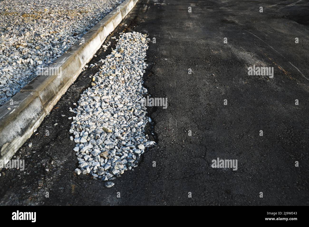 Pit filled with rubble on road close-up. Defect fix on asphalt Stock ...