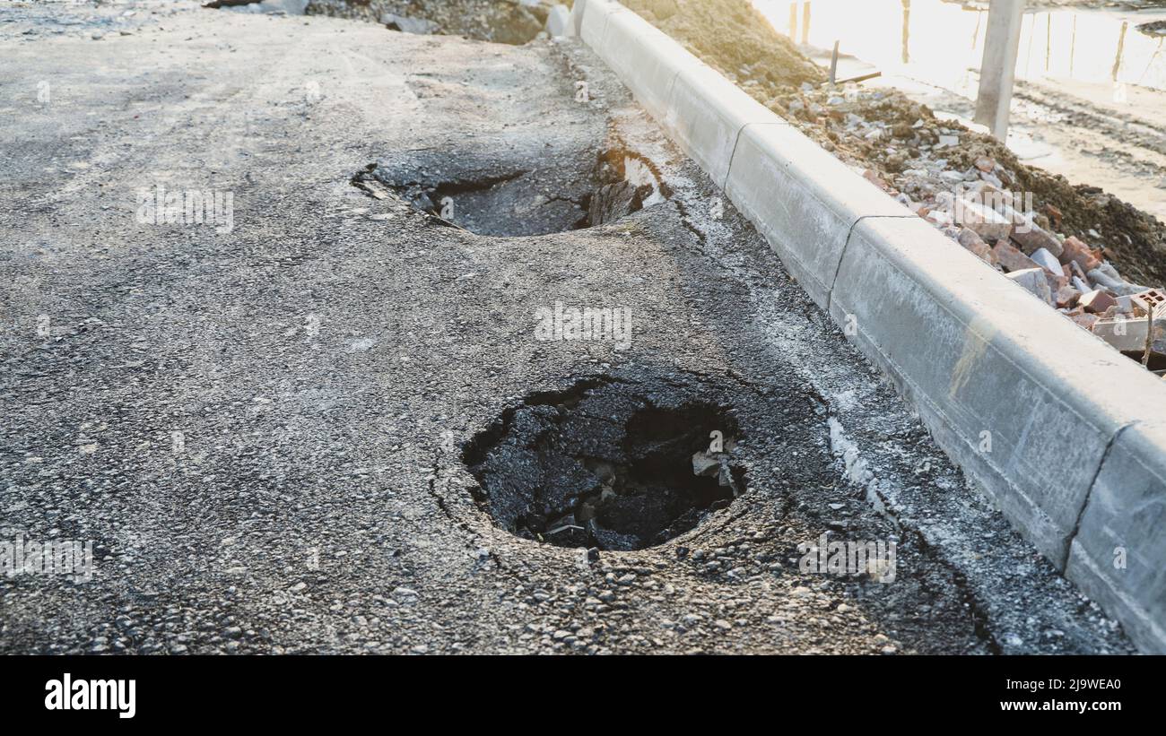 Asphalt swelling close-up. Pothole and pit on road Stock Photo - Alamy