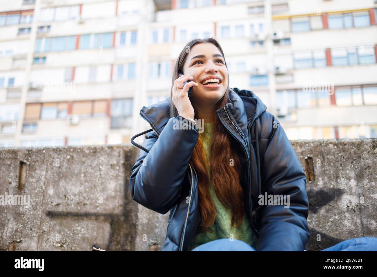 Smiling teenager talking to her close ones using a cellphone Stock ...
