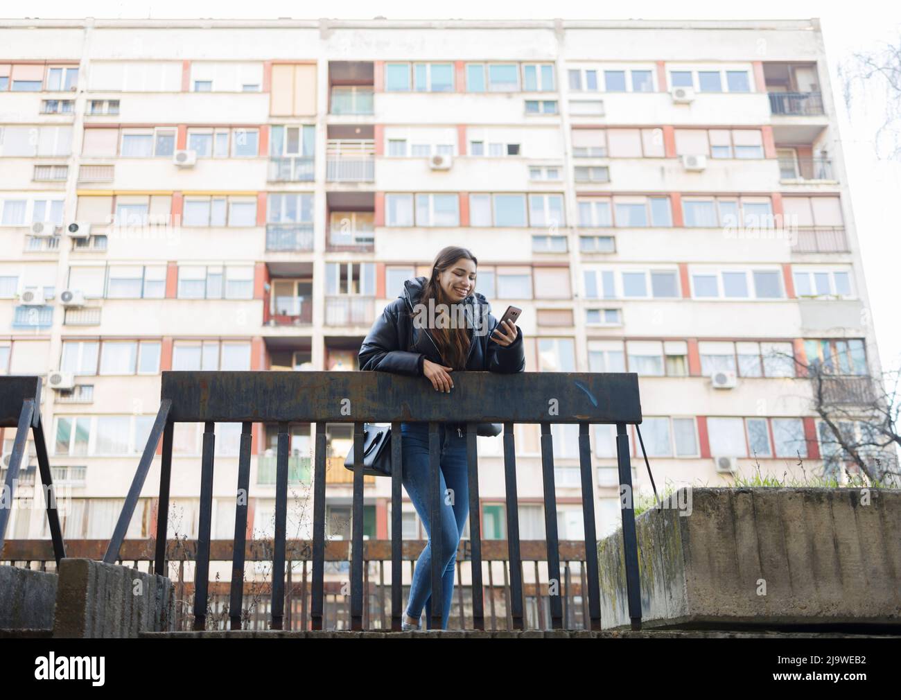 Smiling teenager texting her friends Stock Photo - Alamy