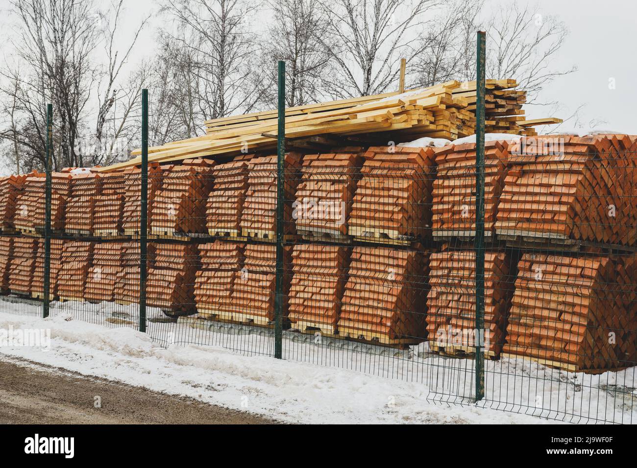 Pallets of bricks for construction. Outdoor storage in winter ...