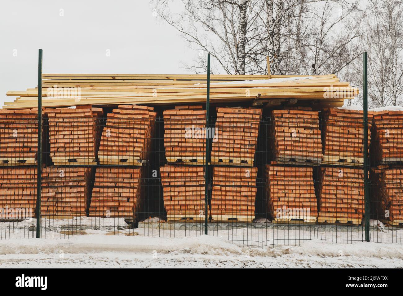 Pallets of bricks for construction. Outdoor storage in winter ...