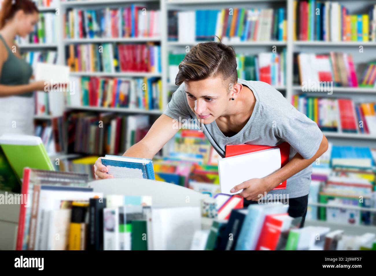 Boy choosing book library hi-res stock photography and images - Alamy
