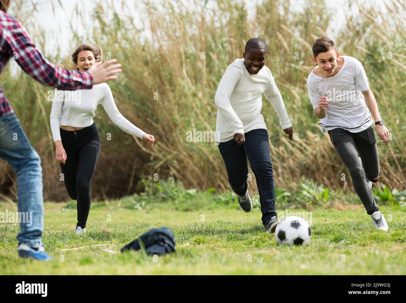 teenage friends playing football Stock Photo - Alamy