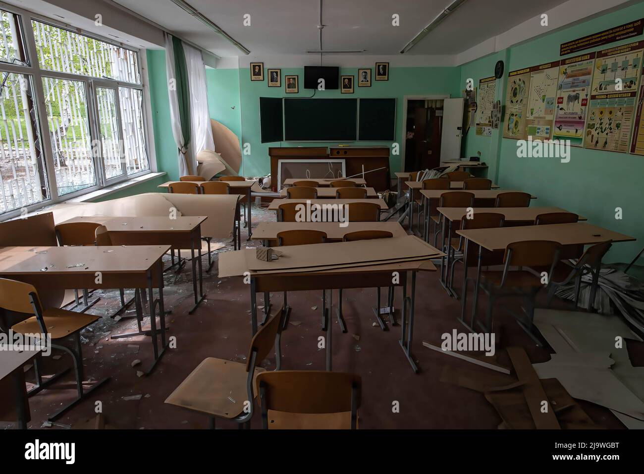 An interior view of a classroom damaged by shelling can be seen in a ...