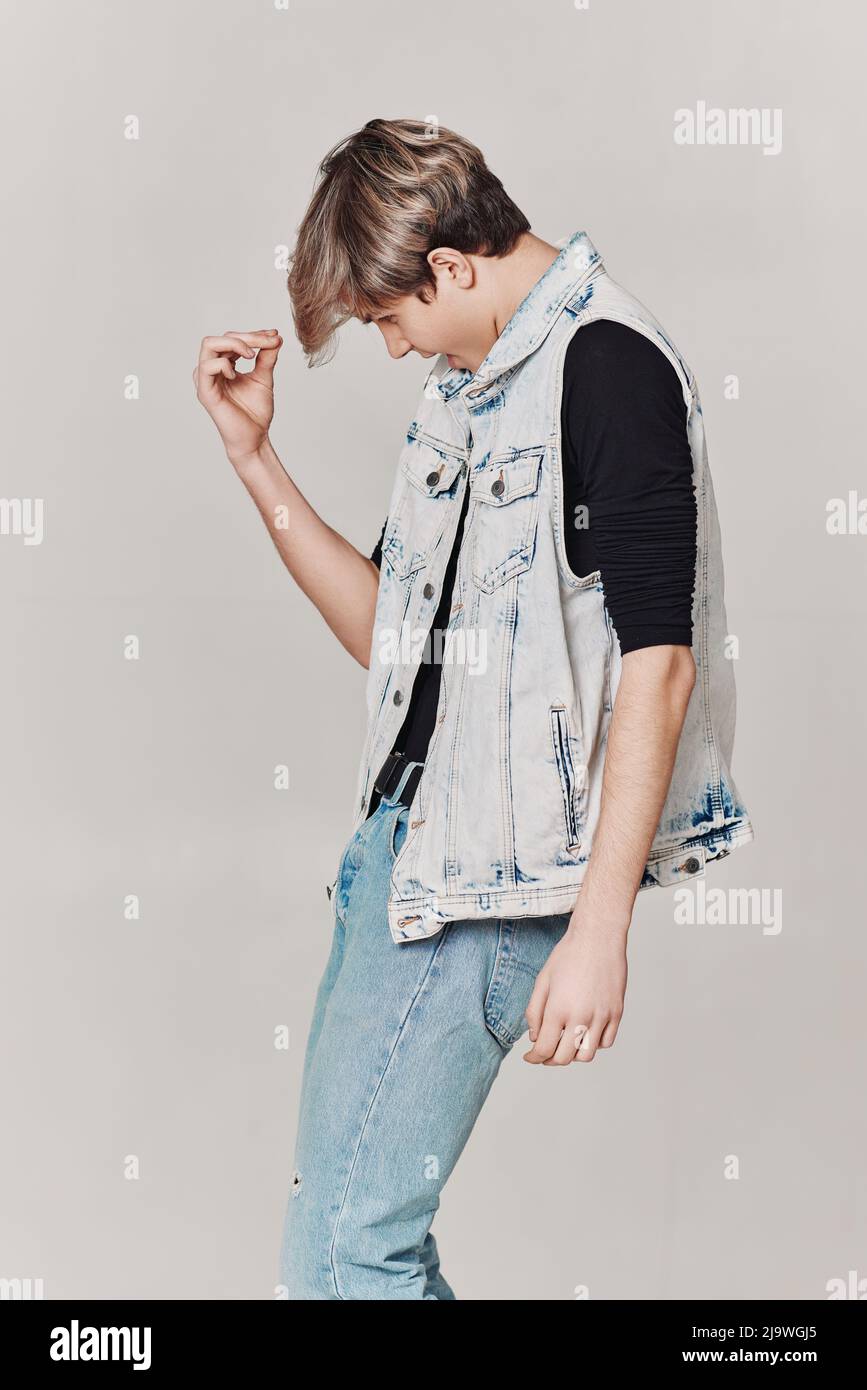 handsome man in denim showing victory gesture Stock Photo - Alamy