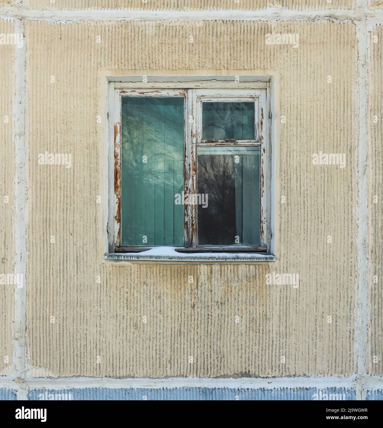 The old yellow panel house. One window Stock Photo - Alamy
