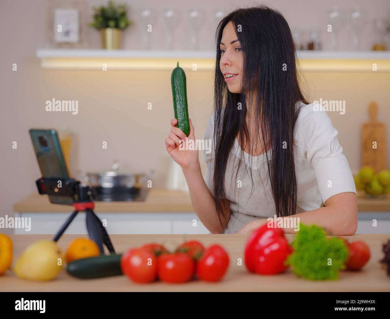 Professional beautiful happy young woman is blogging for her kitchen ...