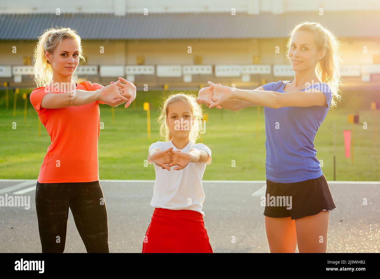 active family at outdoor. two blonde woman twin sisters and their ...