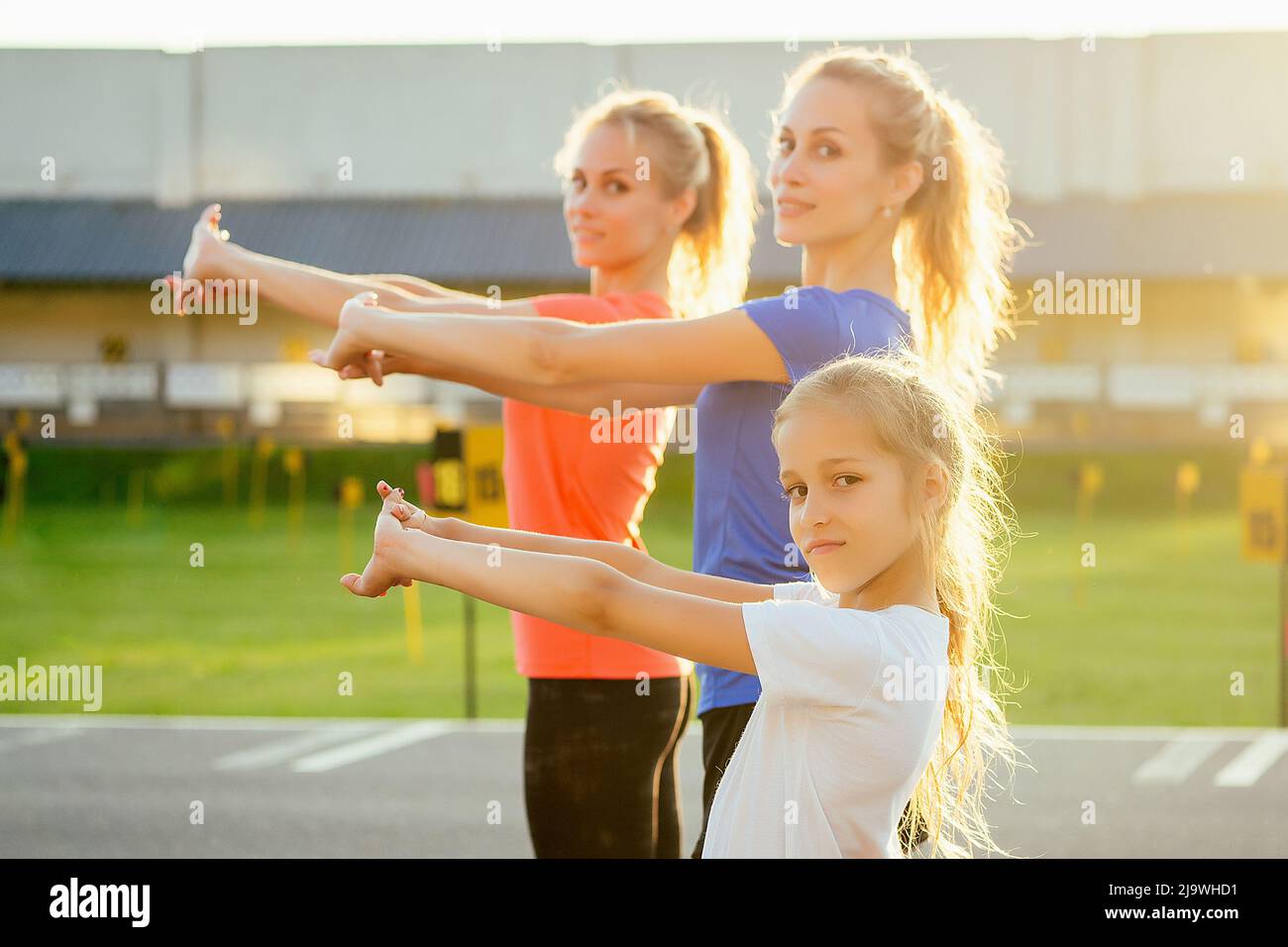 active family at outdoor. two blonde woman twin sisters and their ...
