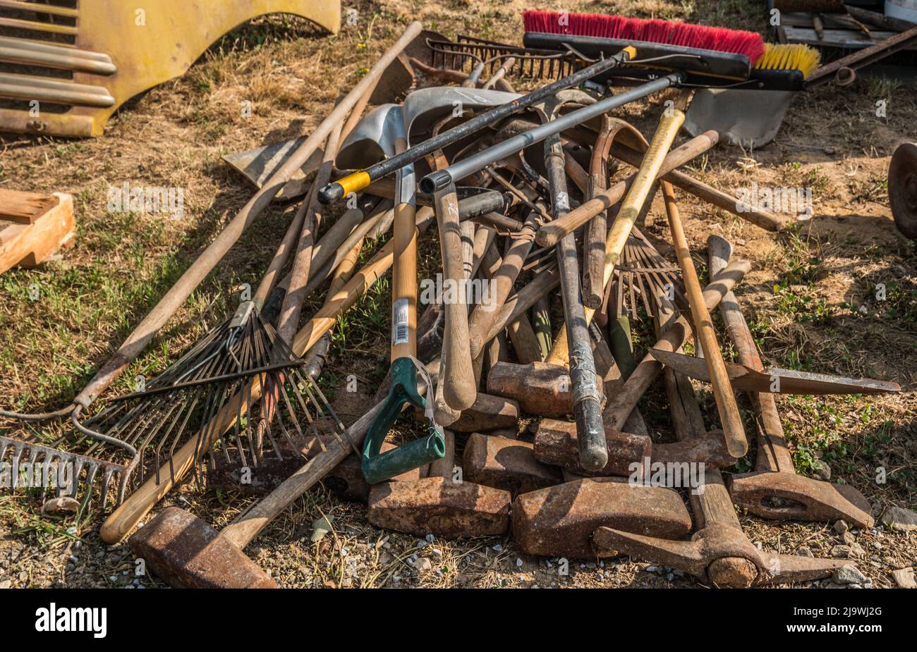 A mound of used outdoor tools for cleanup building and other chores of ...