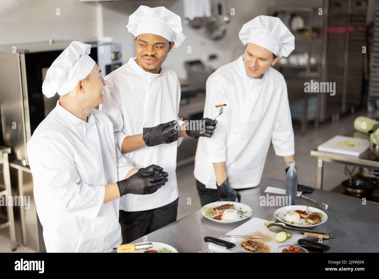 Three cooks with different nationalties tasting cooked meals, inventing ...