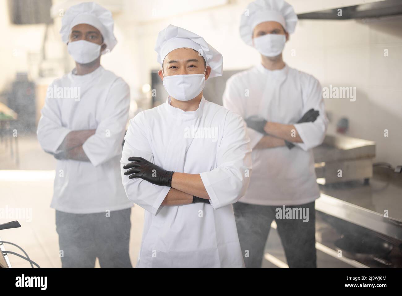 Portrait of three well-dressed chef cooks with different ethnicities ...