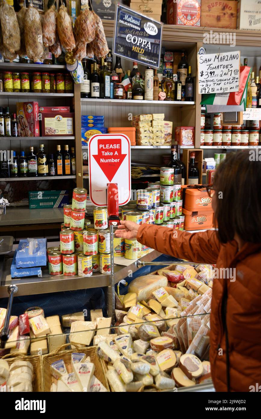 A customer takes a number before ordering a deli sandwich at the ...