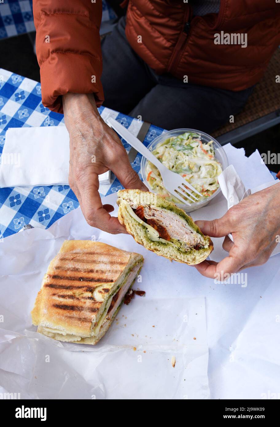 A customer enjoys a sandwich at the landmark Italian-American deli ...