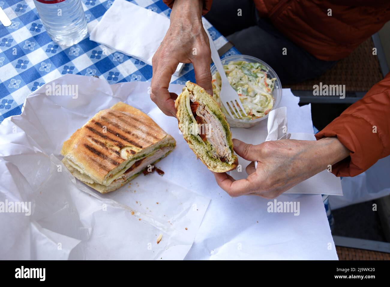 A customer enjoys a sandwich at the landmark Italian-American deli ...