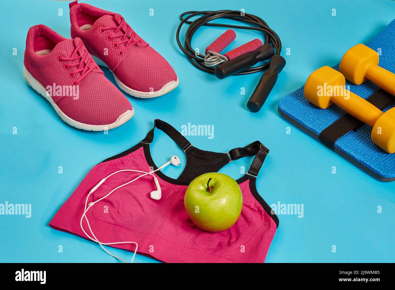 Flat lay of dumbbell, bottle of water, jump rope and sneaker, sport ...