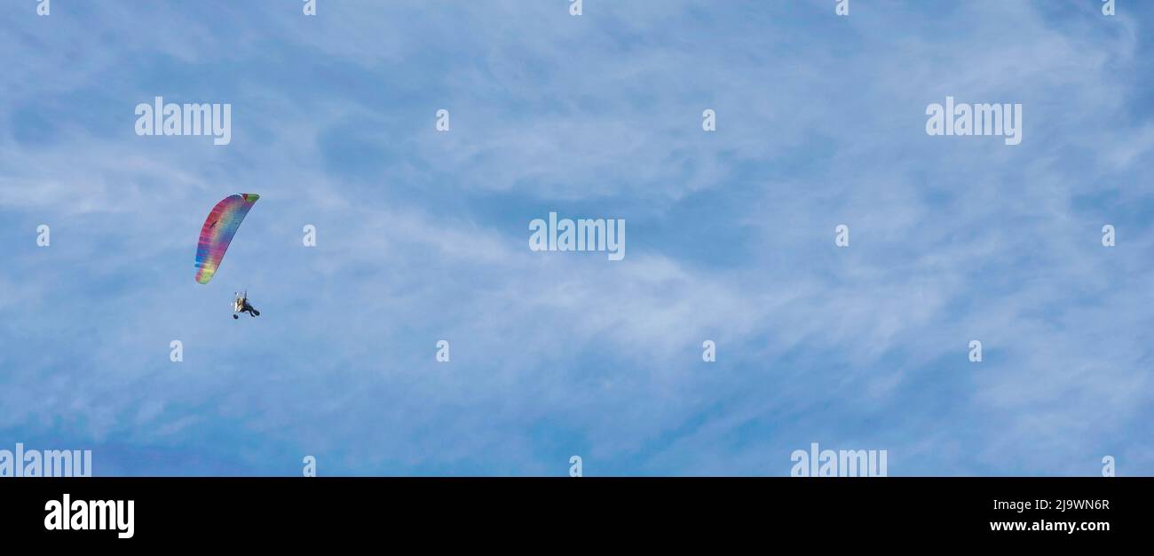 Unrecognizable adventure active extreme sports pilot flying in the sky ...