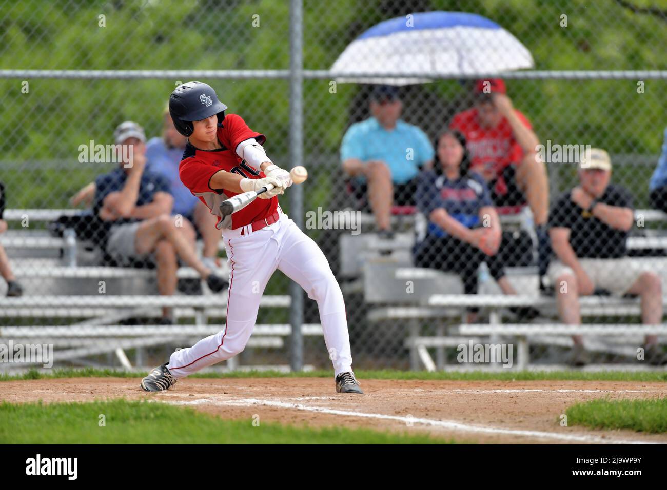 USA. Hitter driving a single to right field to drive in a run during a ...