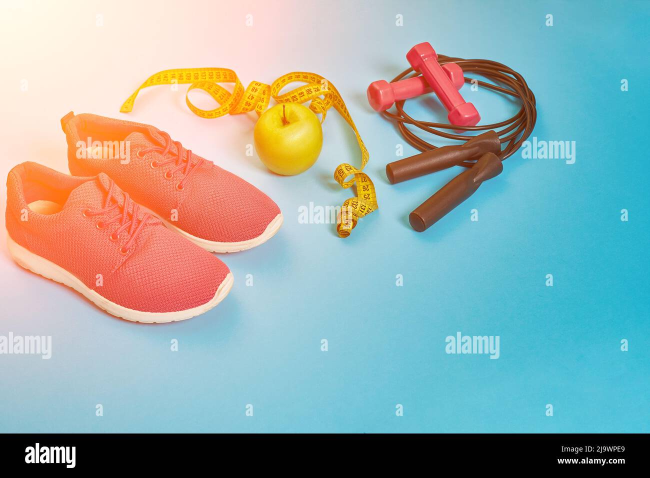 Flat lay of dumbbell, bottle of water, jump rope and sneaker, sport ...