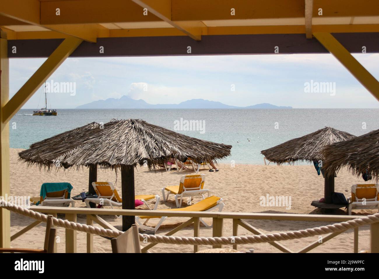 Peaceful Tropical Beach Scene with Thatched Umbrellas and Ocean View ...