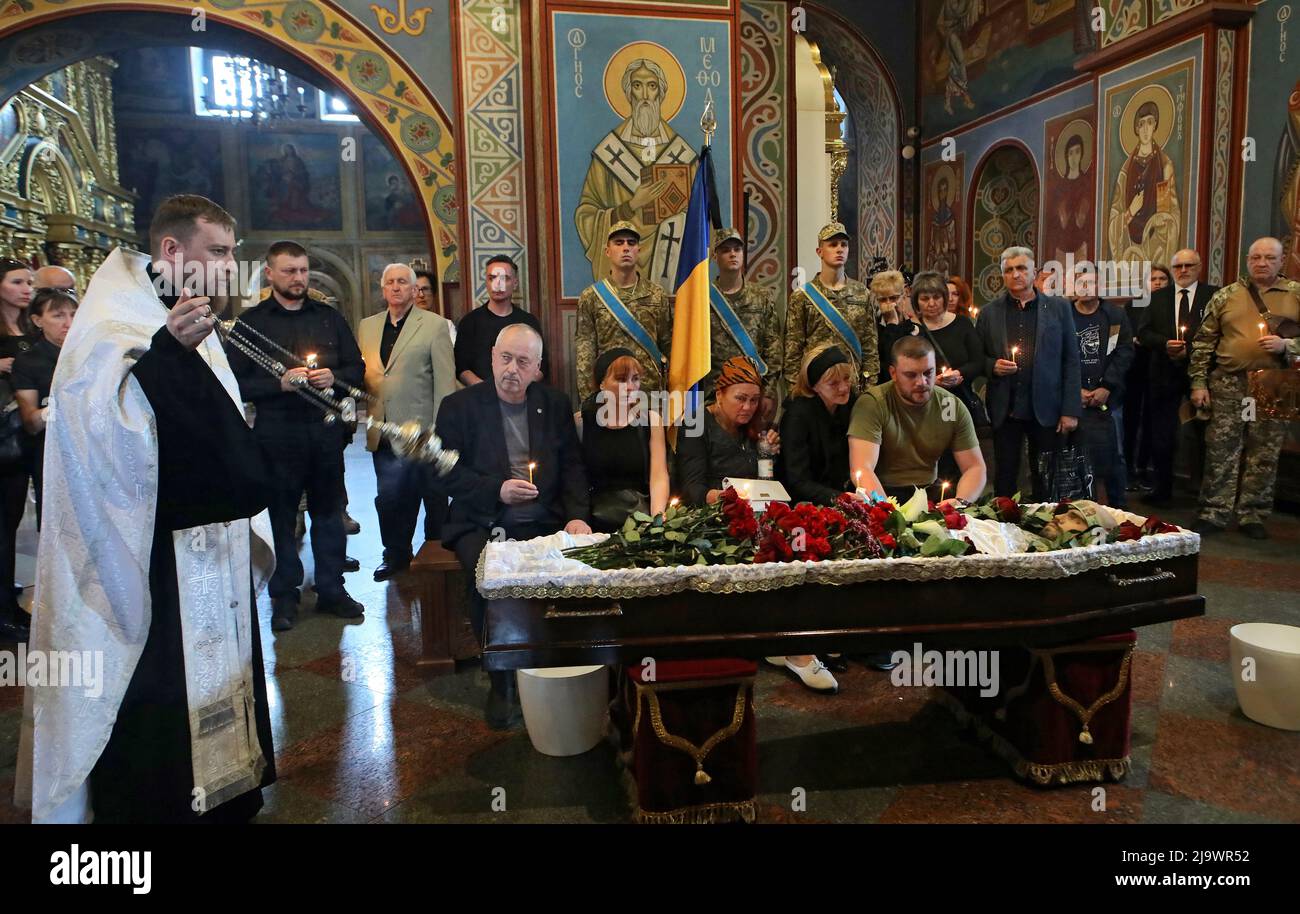 KYIV, UKRAINE - MAY 25, 2022 - A priest conducts a funeral service by ...