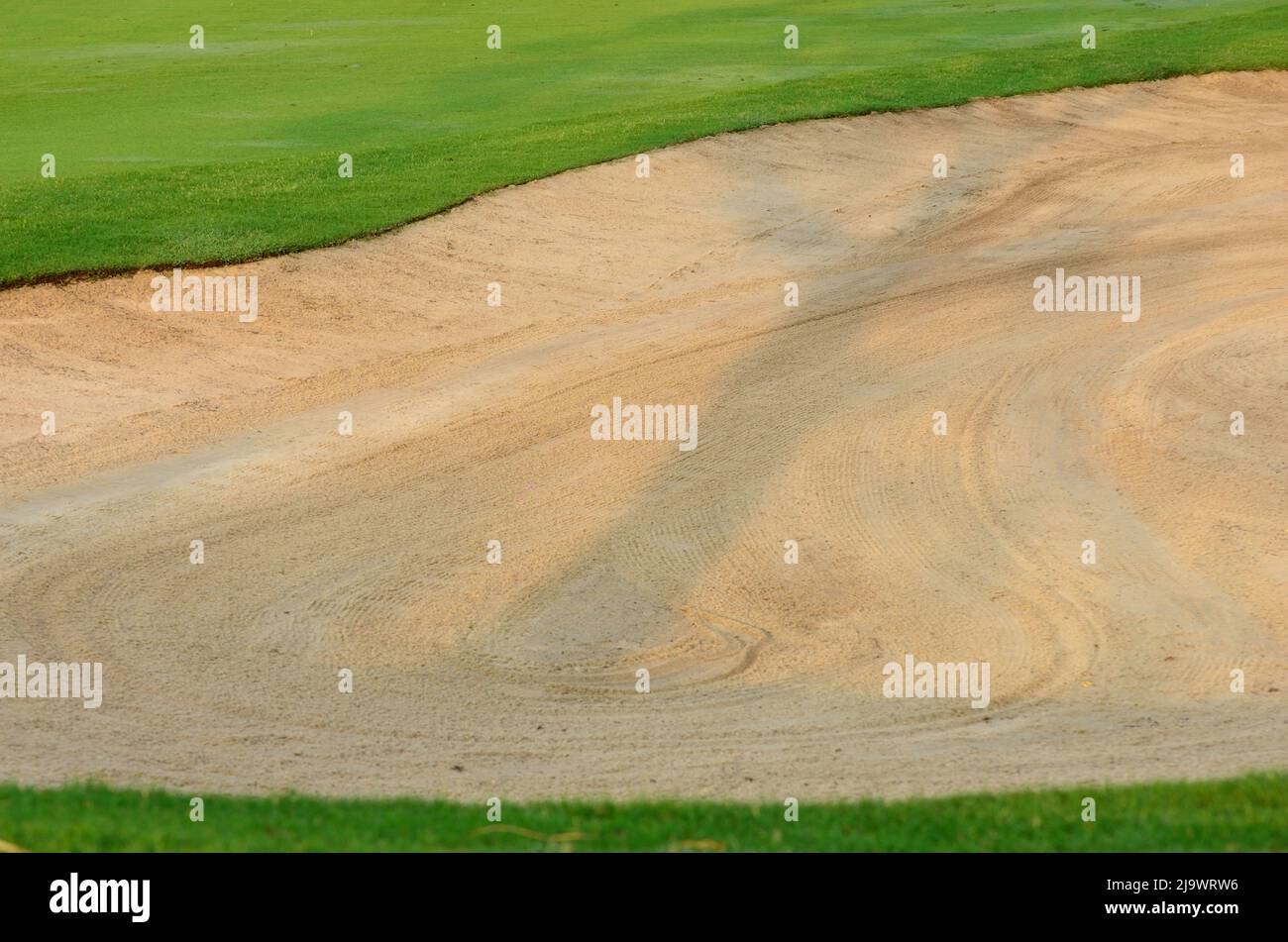 Sand bunker on green golf fairway Stock Photo - Alamy