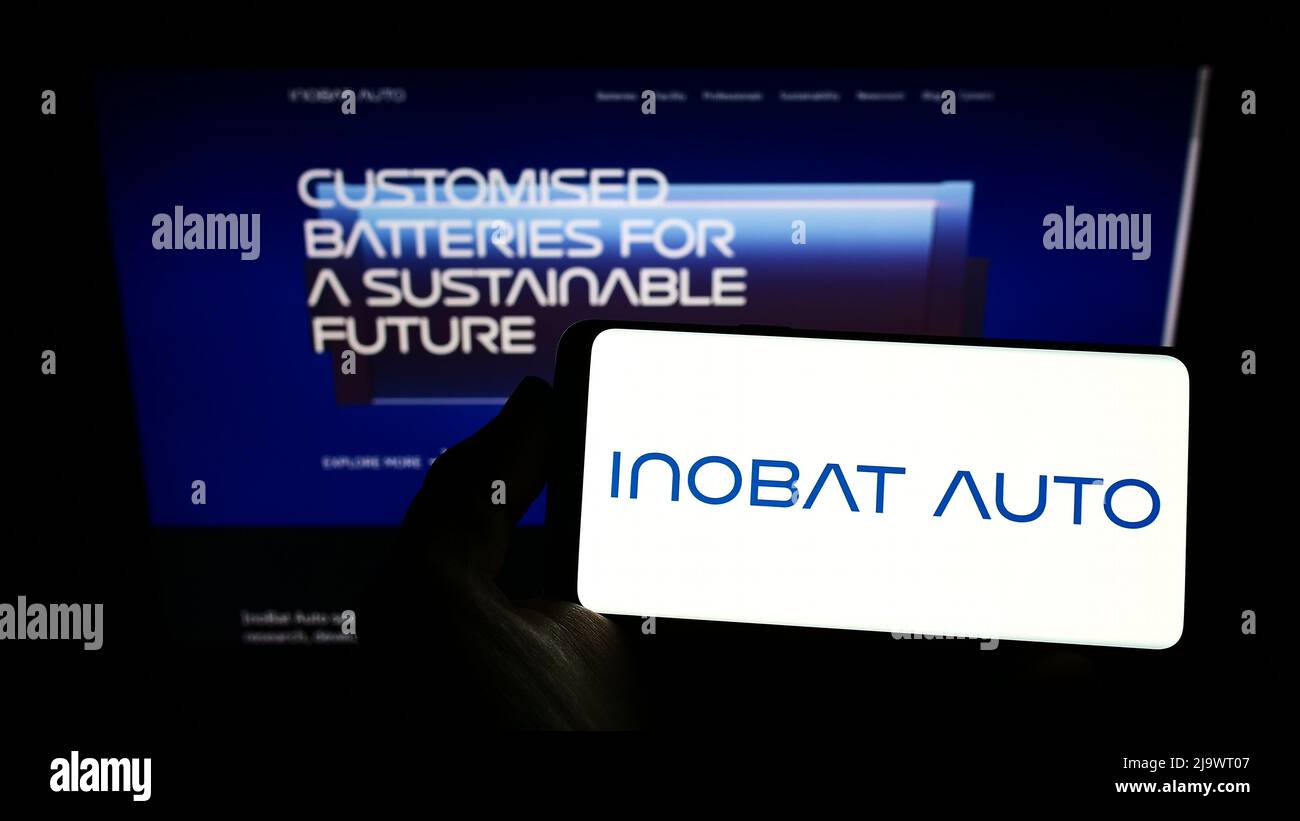 Person holding smartphone with logo of Slovak battery company InoBat ...