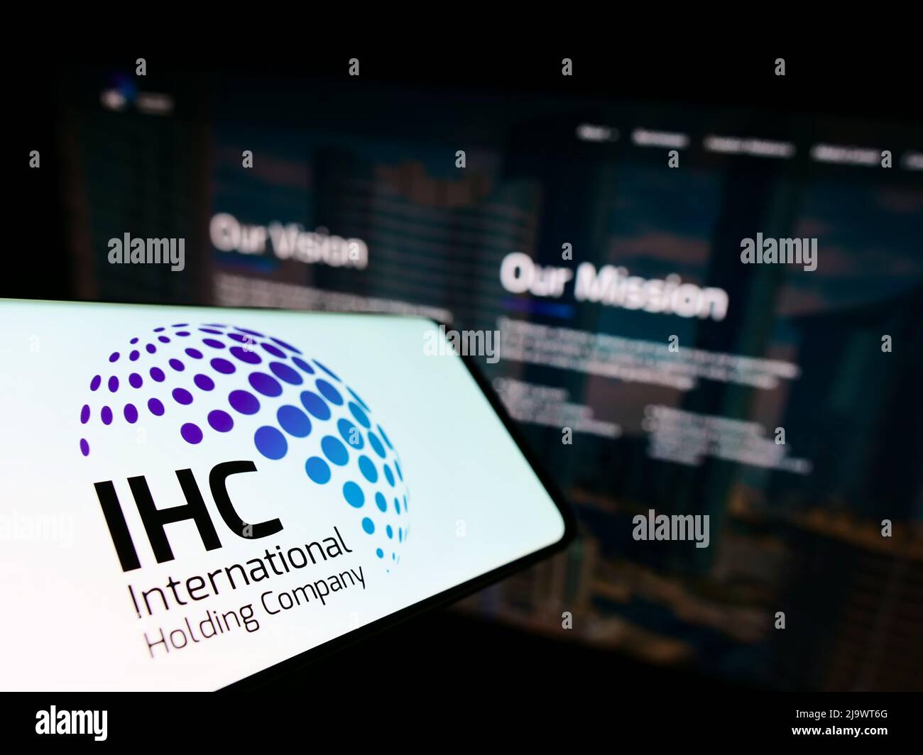 Cellphone with logo of Emirati International Holding Company PJSC (IHC ...