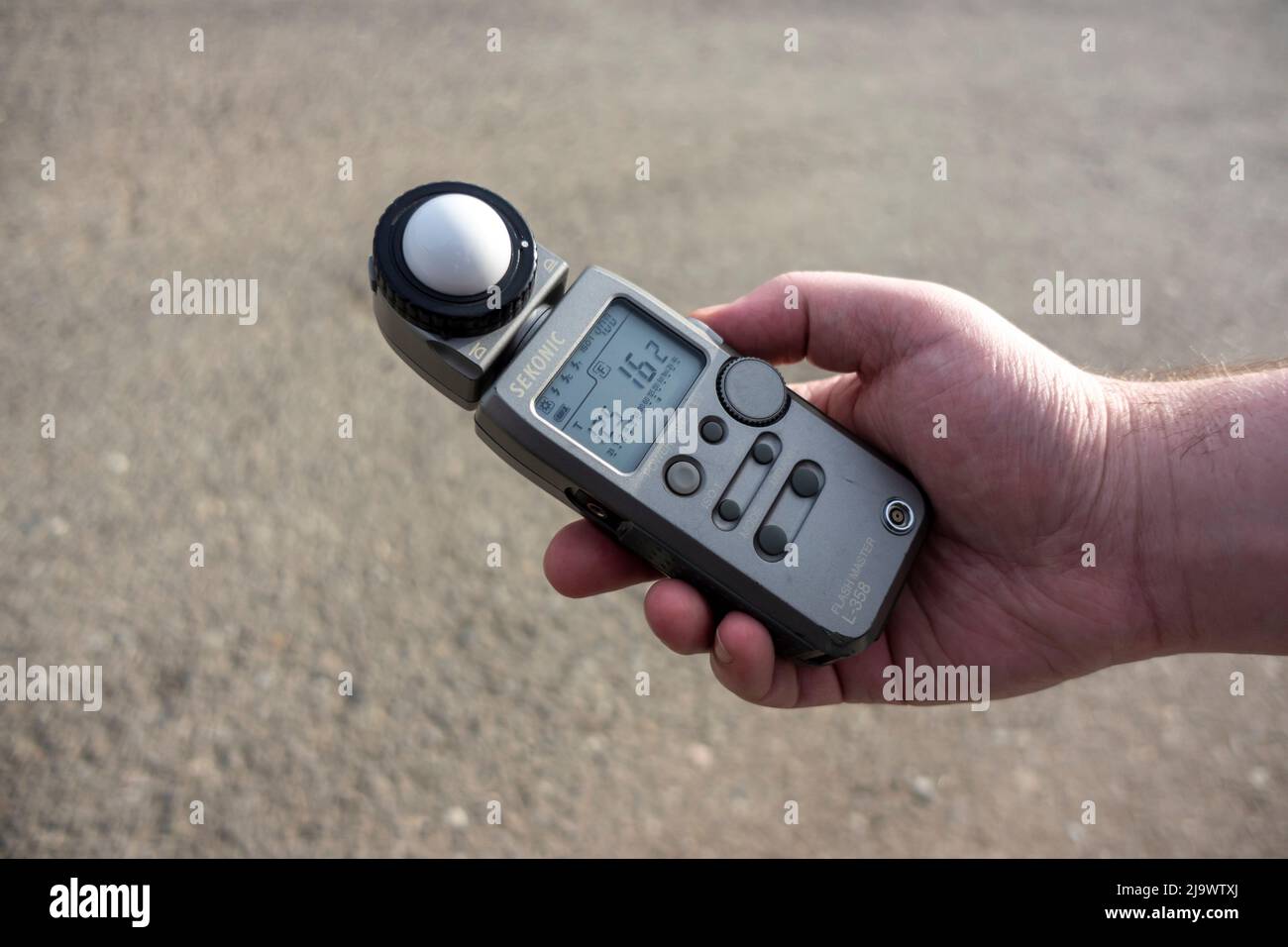 Seattle, WA USA - circa May 2022: View of a man holding a Sekonic light ...
