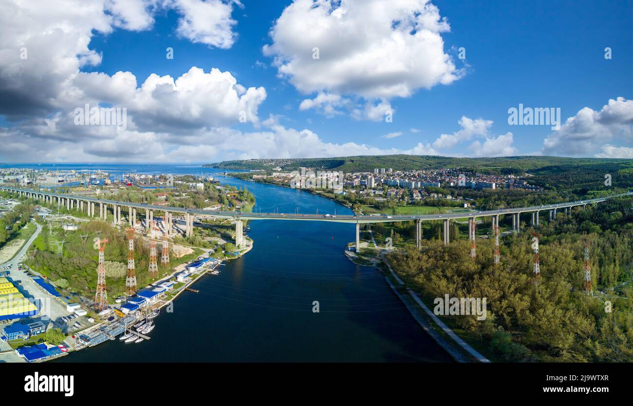 Panorama of bird's eye view of concrete sturdy road bridge between land ...