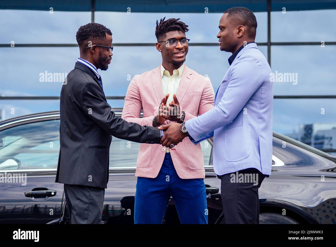 A group of three stylish African American businessman friends ...
