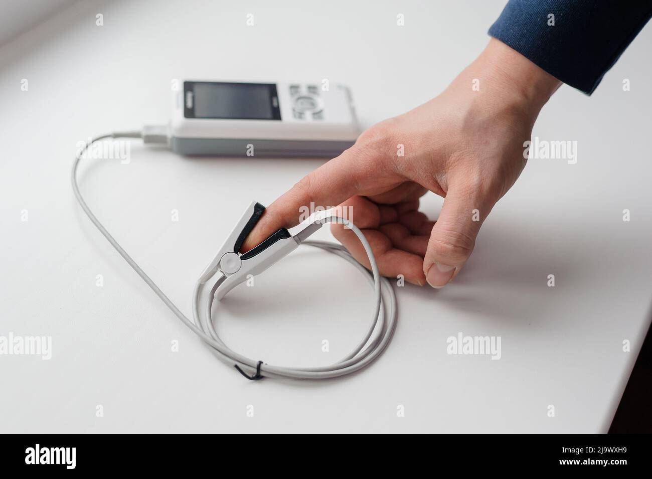 Man using finger pulse oximeter, healthcare monitoring concept. Pulse ...