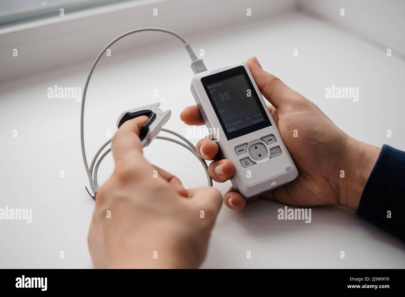 Man using finger pulse oximeter, healthcare monitoring concept. Pulse ...