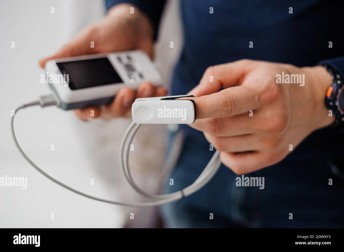 Man using finger pulse oximeter, healthcare monitoring concept. Pulse ...