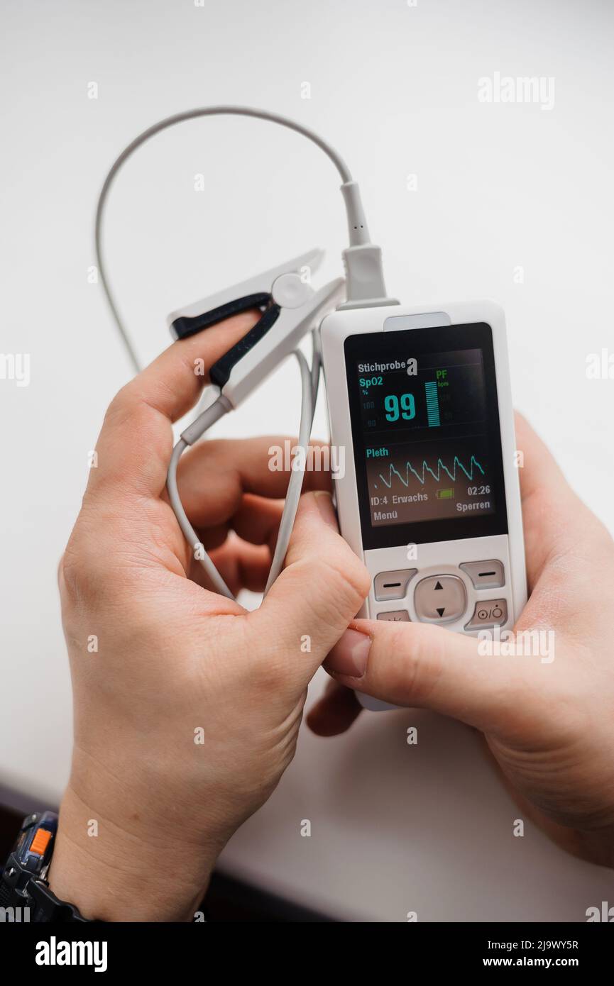 Man using finger pulse oximeter, healthcare monitoring concept. Pulse ...