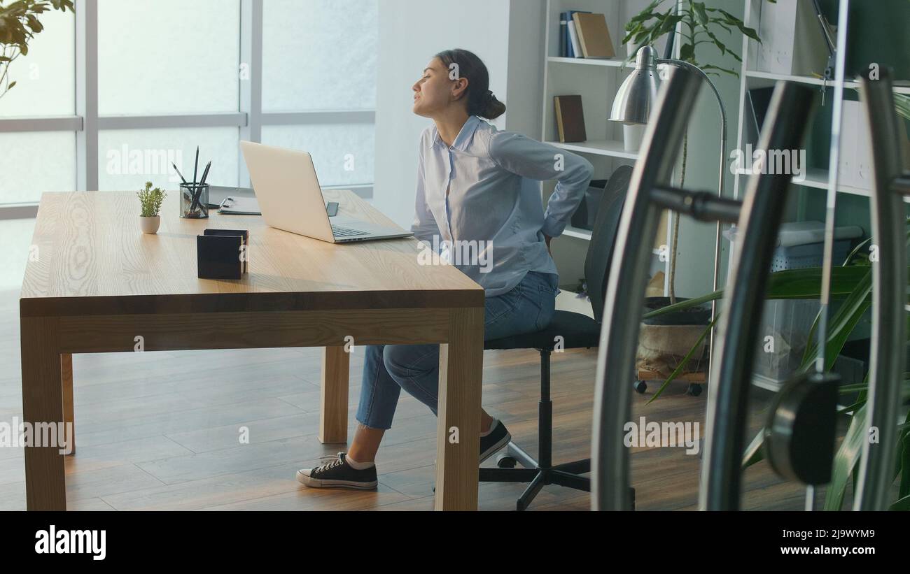 Woman Trying to Get Up From the Table Suddenly Feeling Pain in Back ...